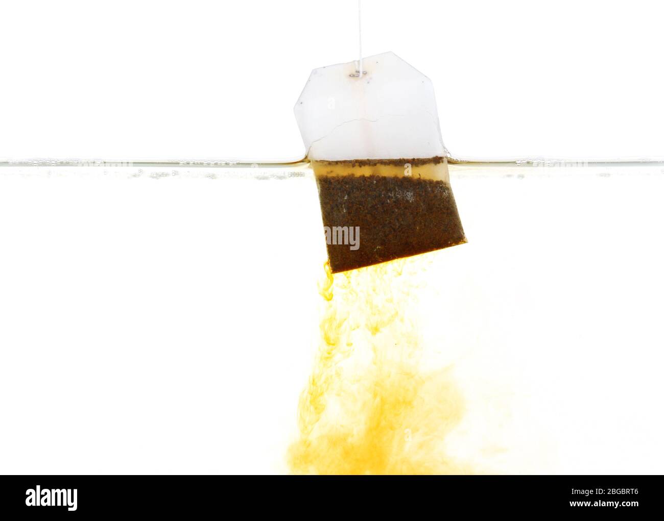 Tea bag dipped in hot water Stock Photo - Alamy