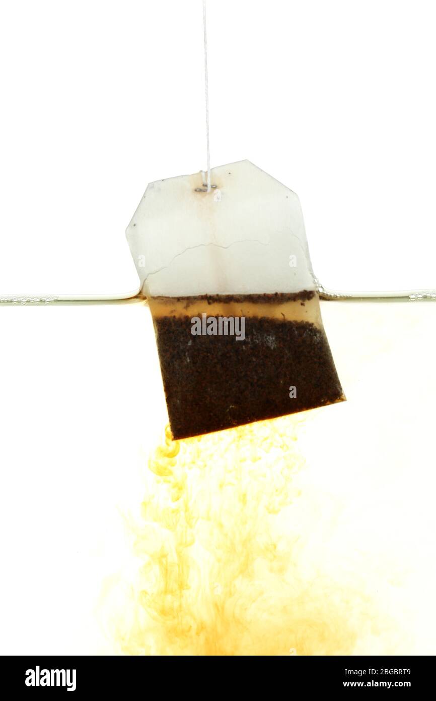 Tea bag dipped in hot water Stock Photo - Alamy