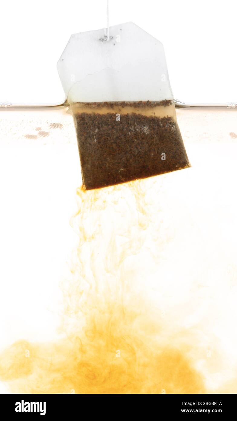 Tea bag dipped in hot water Stock Photo - Alamy
