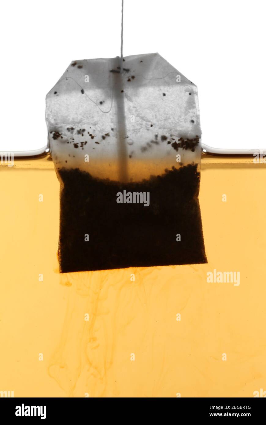 Tea bag dipped in hot water Stock Photo - Alamy