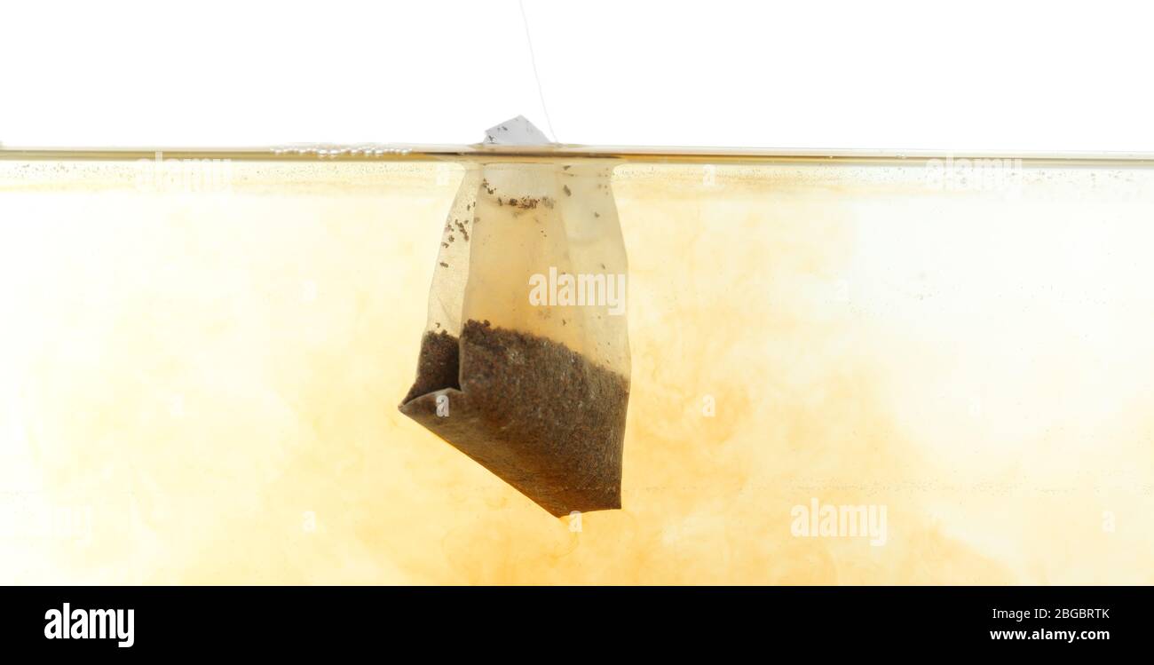 Tea bag dipped in hot water Stock Photo - Alamy