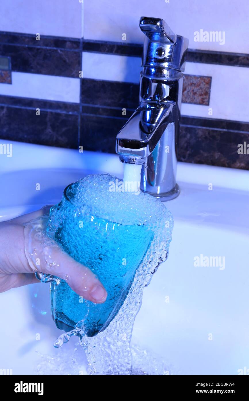 Filling up glass of water Stock Photo - Alamy