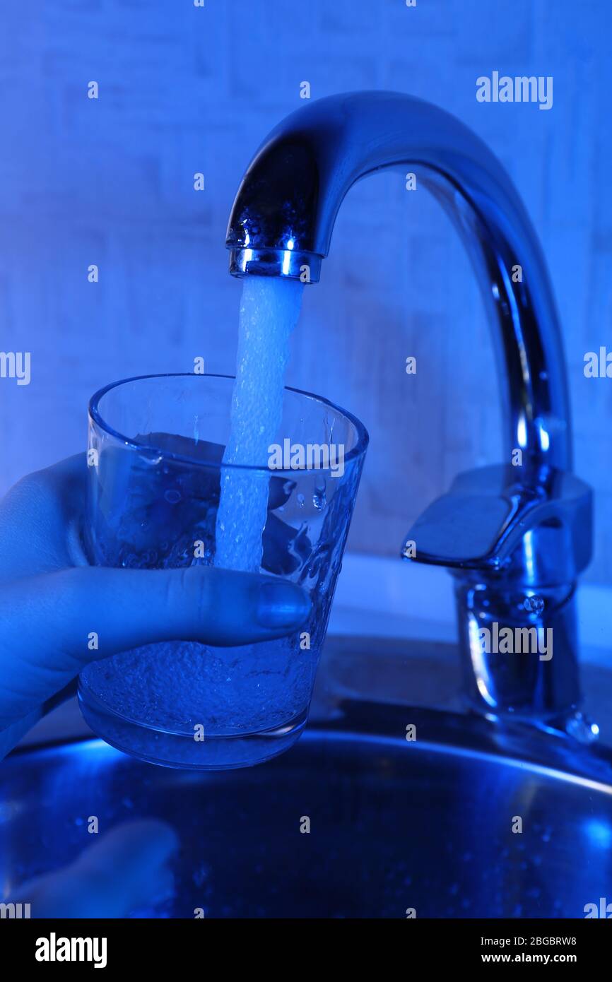 Filling up glass of water Stock Photo - Alamy