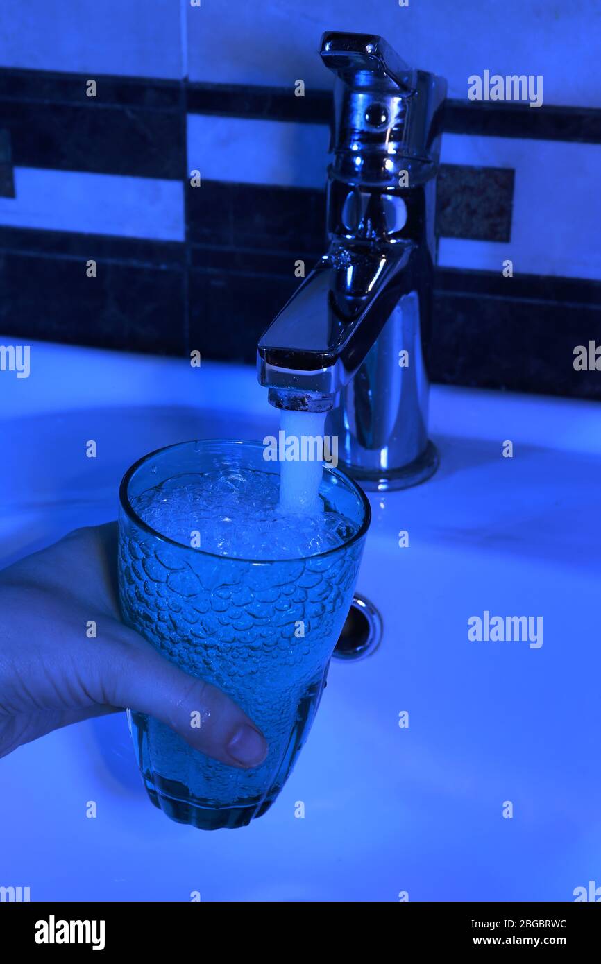 Filling up glass of water Stock Photo - Alamy