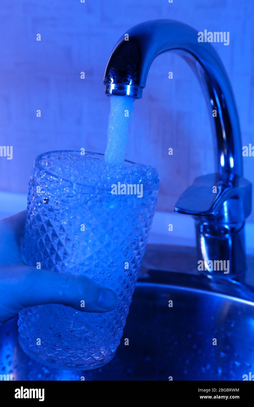 Filling up glass of water Stock Photo - Alamy