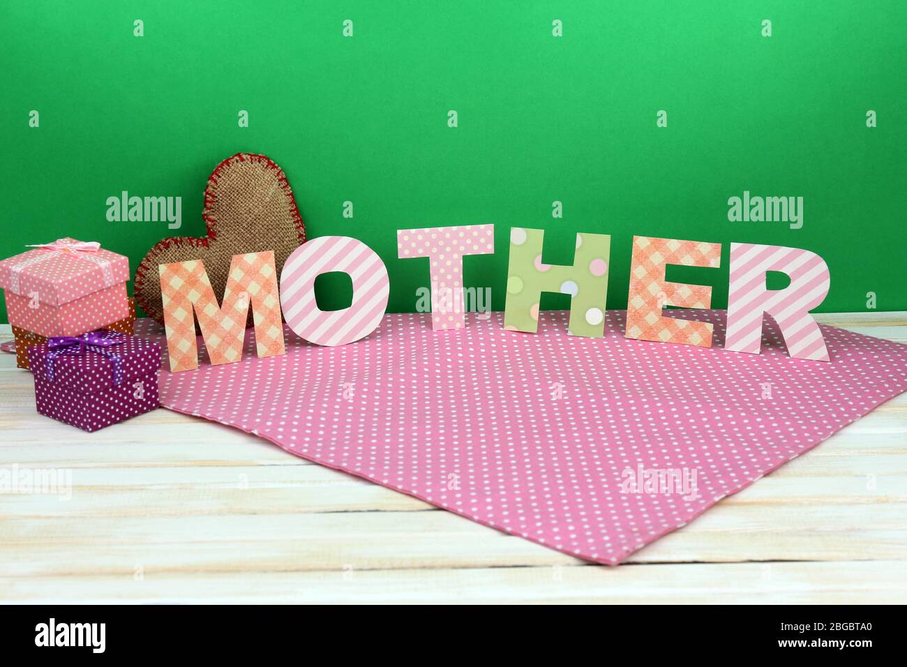 Mother- lettering of handmade paper letters on green background Stock ...
