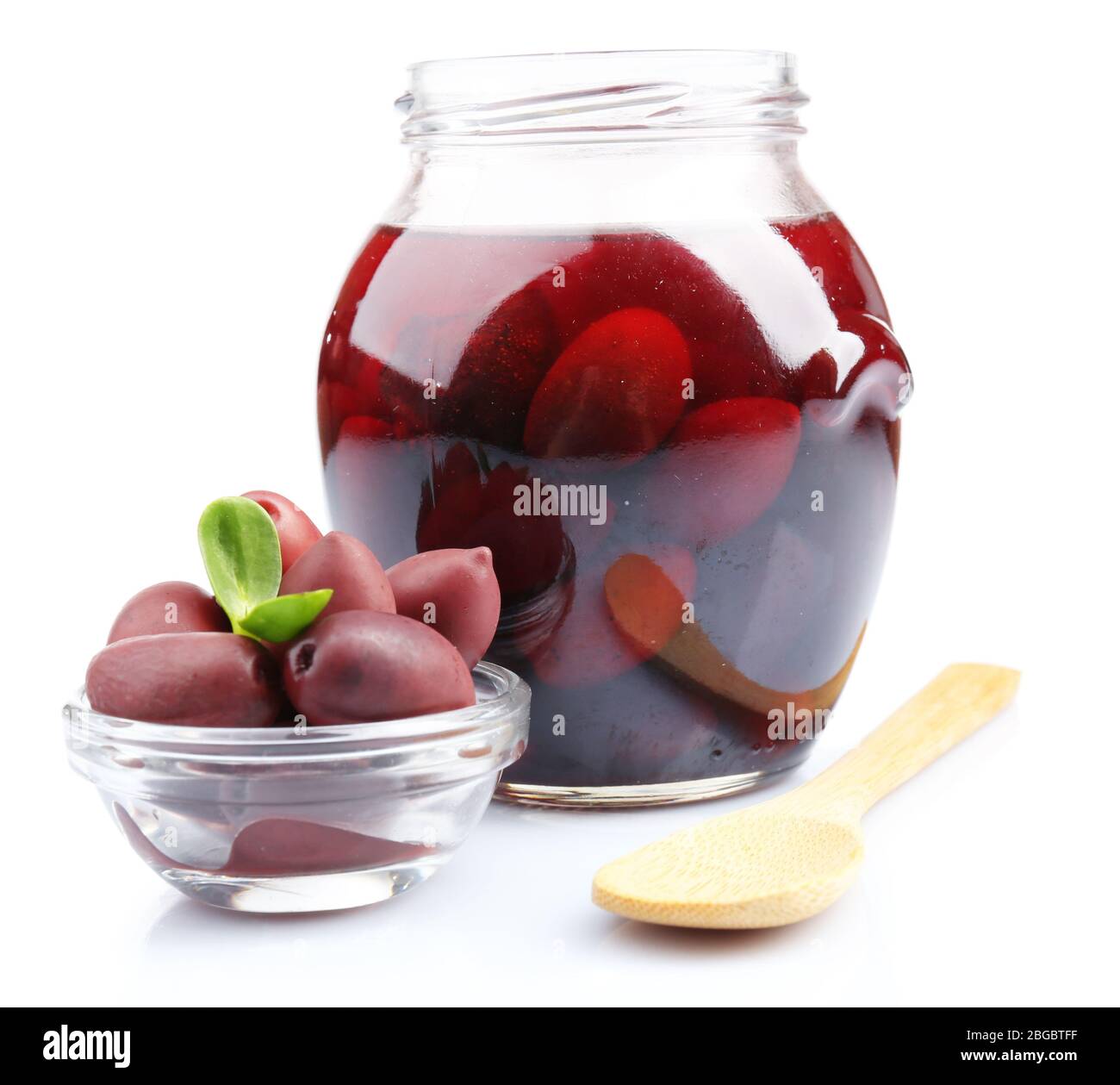 Black olives in glass jar, isolated on white Stock Photo - Alamy