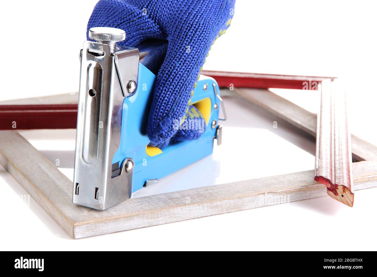 Fastening wooden frame using construction stapler isolated on white ...