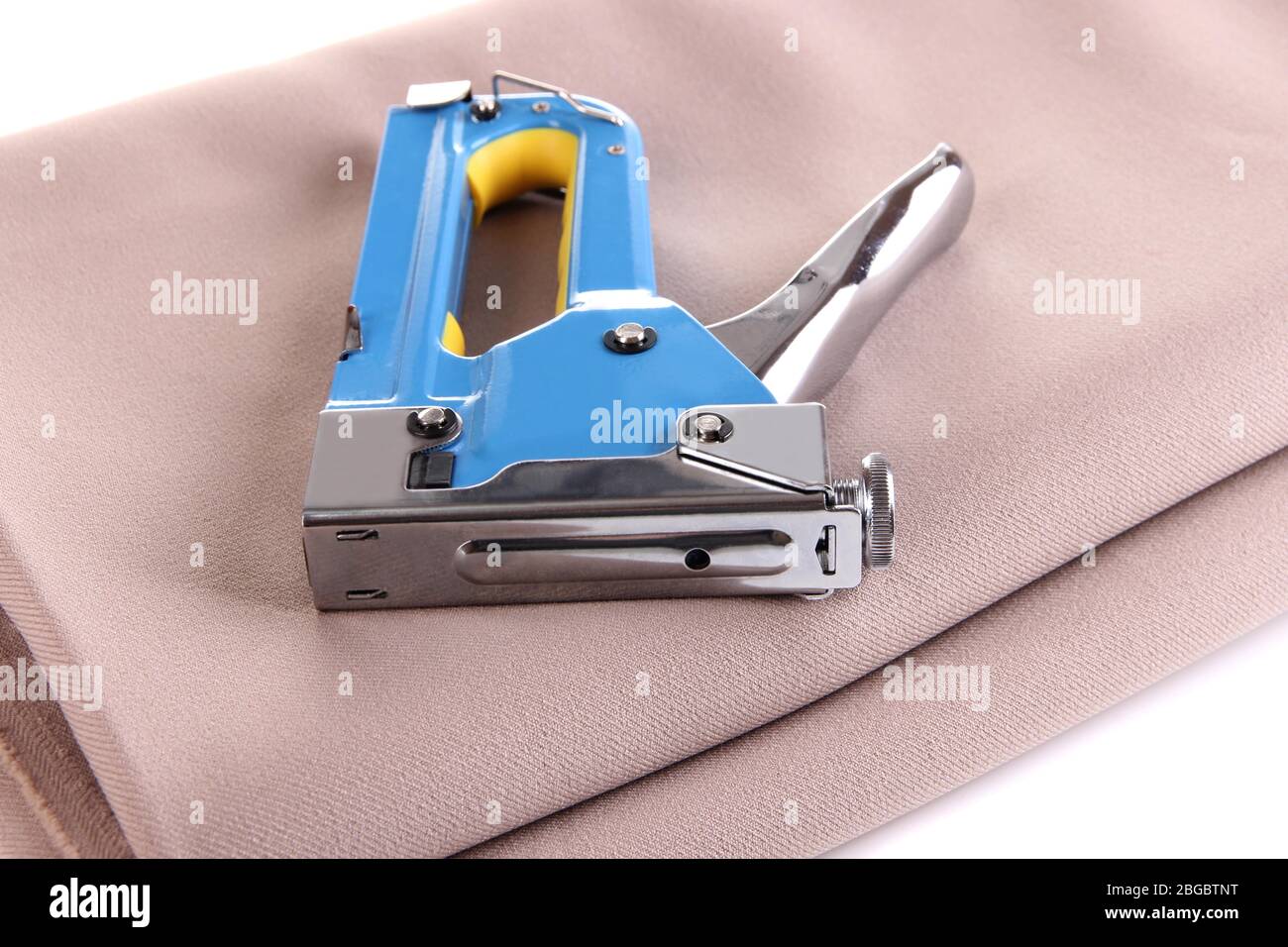 Construction stapler on fabric close up Stock Photo - Alamy