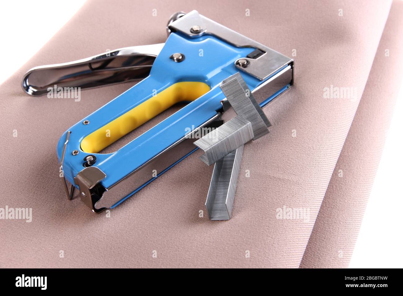 Construction stapler on fabric close up Stock Photo - Alamy