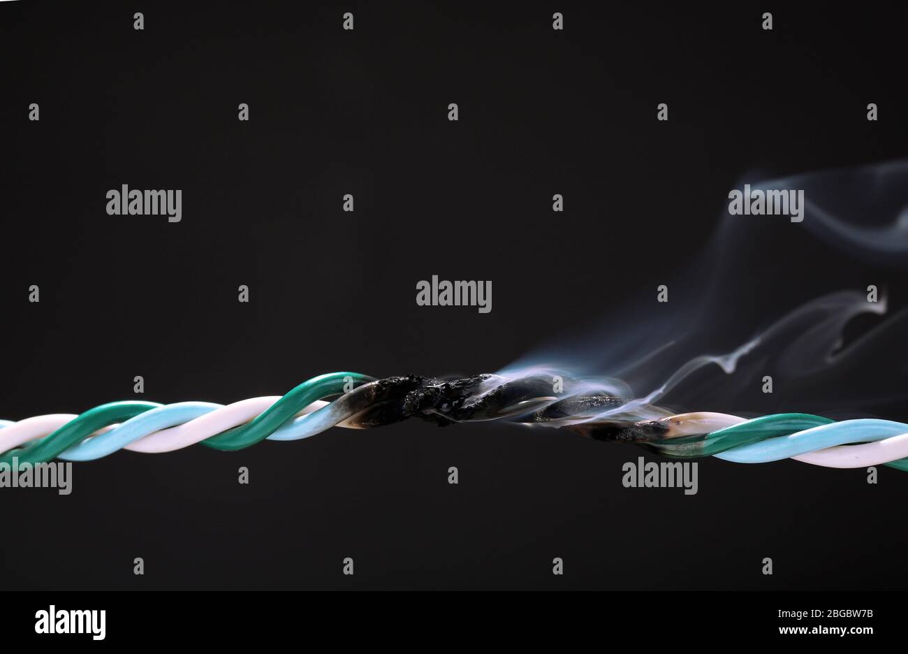 Short circuit, burnt cable, isolated on black Stock Photo - Alamy