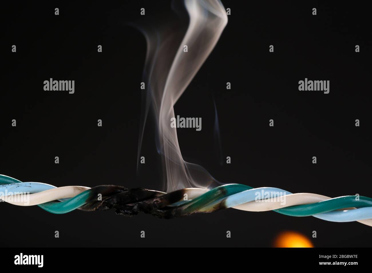 Short circuit, burnt cable, isolated on black Stock Photo - Alamy