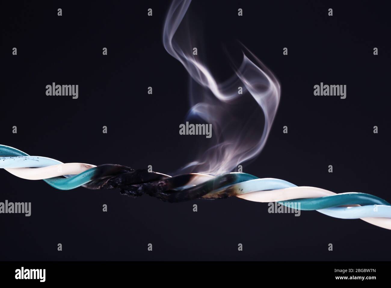 Short circuit, burnt cable, isolated on black Stock Photo - Alamy