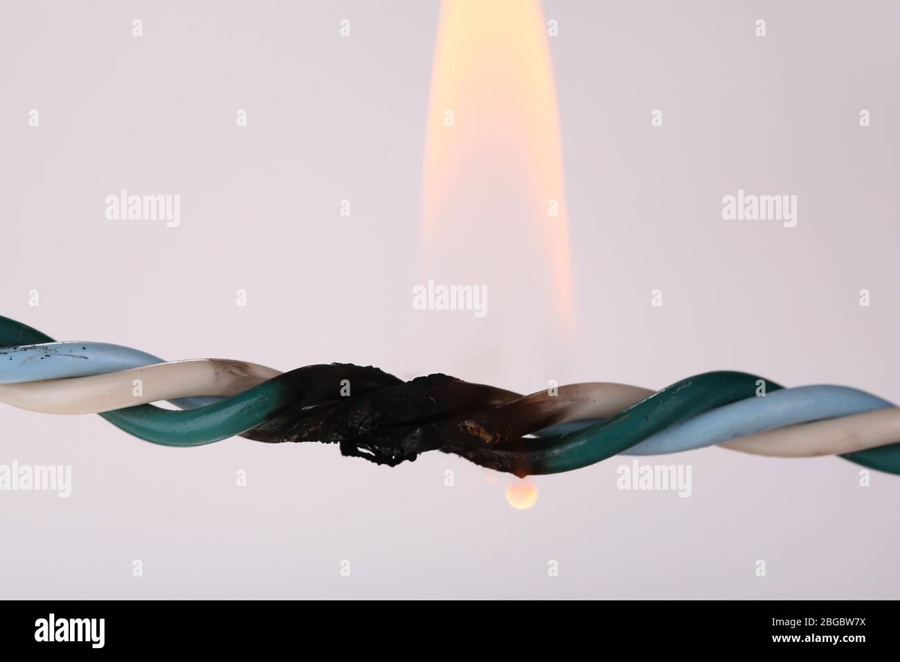 Short circuit, burnt cable, isolated on white Stock Photo - Alamy