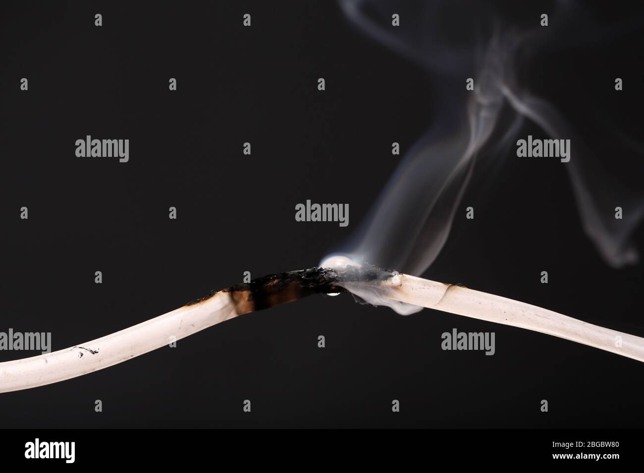 Short circuit, burnt cable, isolated on black Stock Photo - Alamy