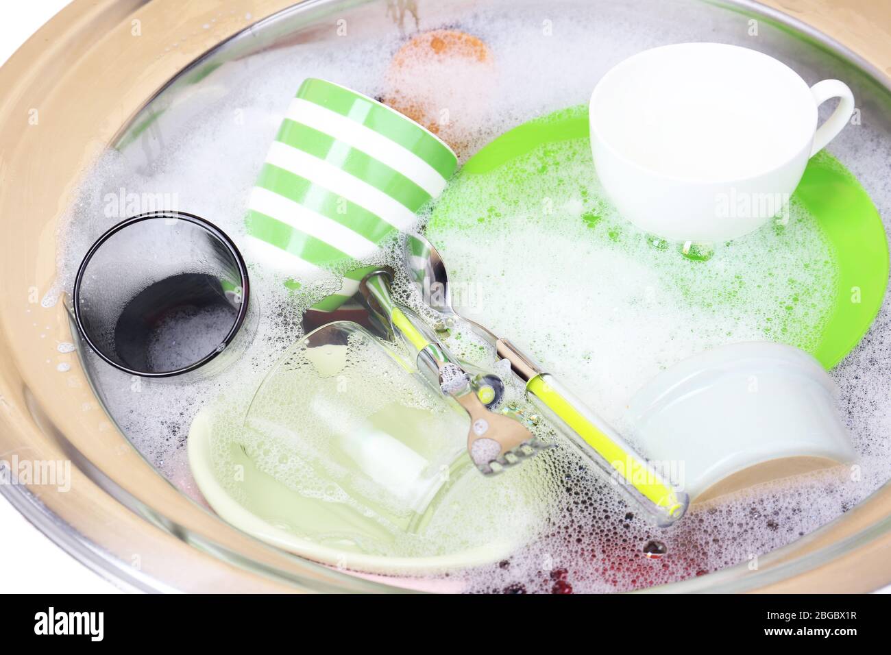 Utensils soaking in kitchen sink Stock Photo - Alamy