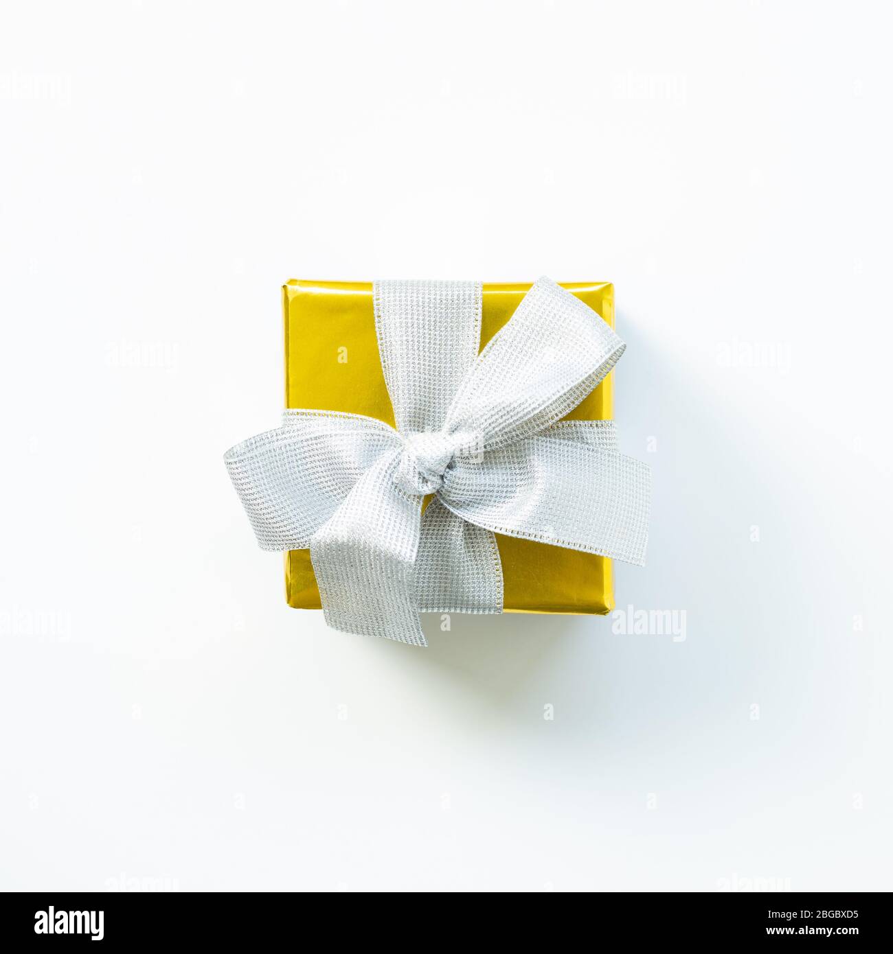 Gold shiny metallic gift box isolated on white background. top view ...