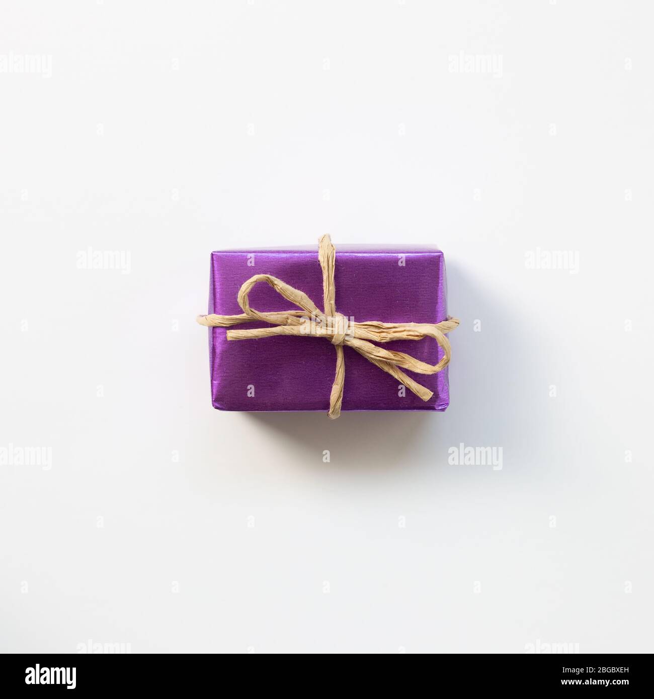Purple shiny metallic gift box isolated on white background. top view ...