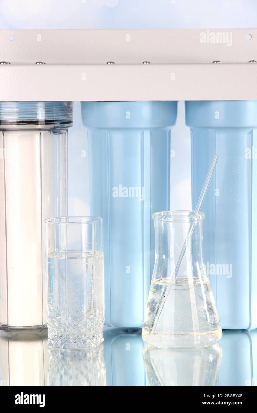 Filter system for water treatment with glass and bulb on bright ...