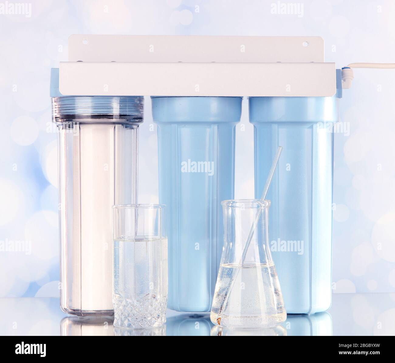 Filter system for water treatment with glass and bulb on bright ...