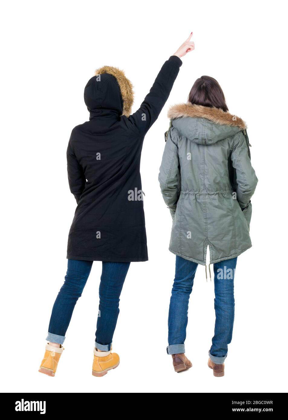 Back view of two pointing girl in winter jacket. Rear view people ...