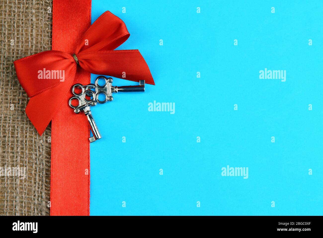 Sackcloth with color ribbon and bow on color paper background Stock ...