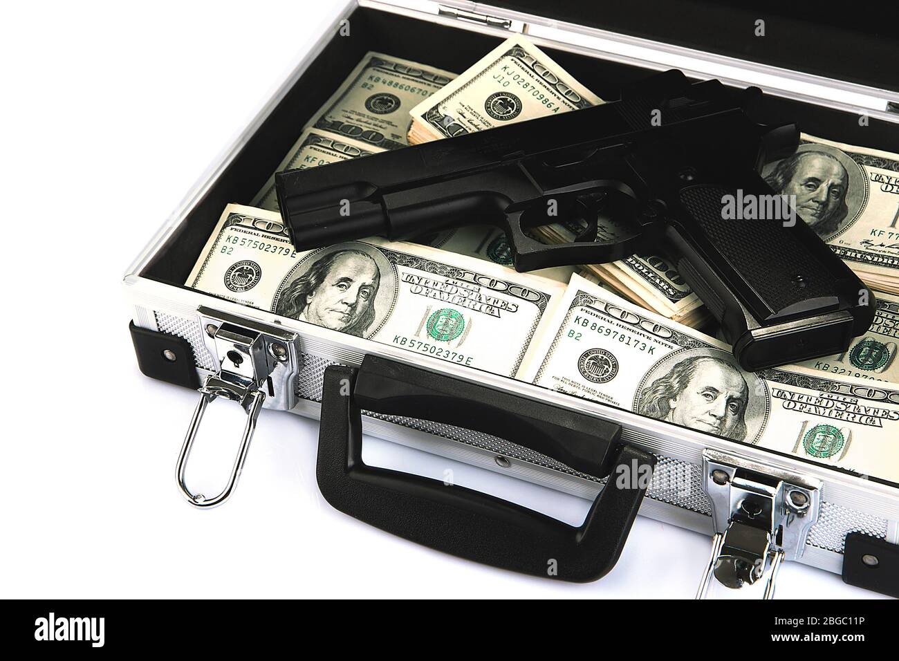 Case with money and gun, isolated on white Stock Photo - Alamy