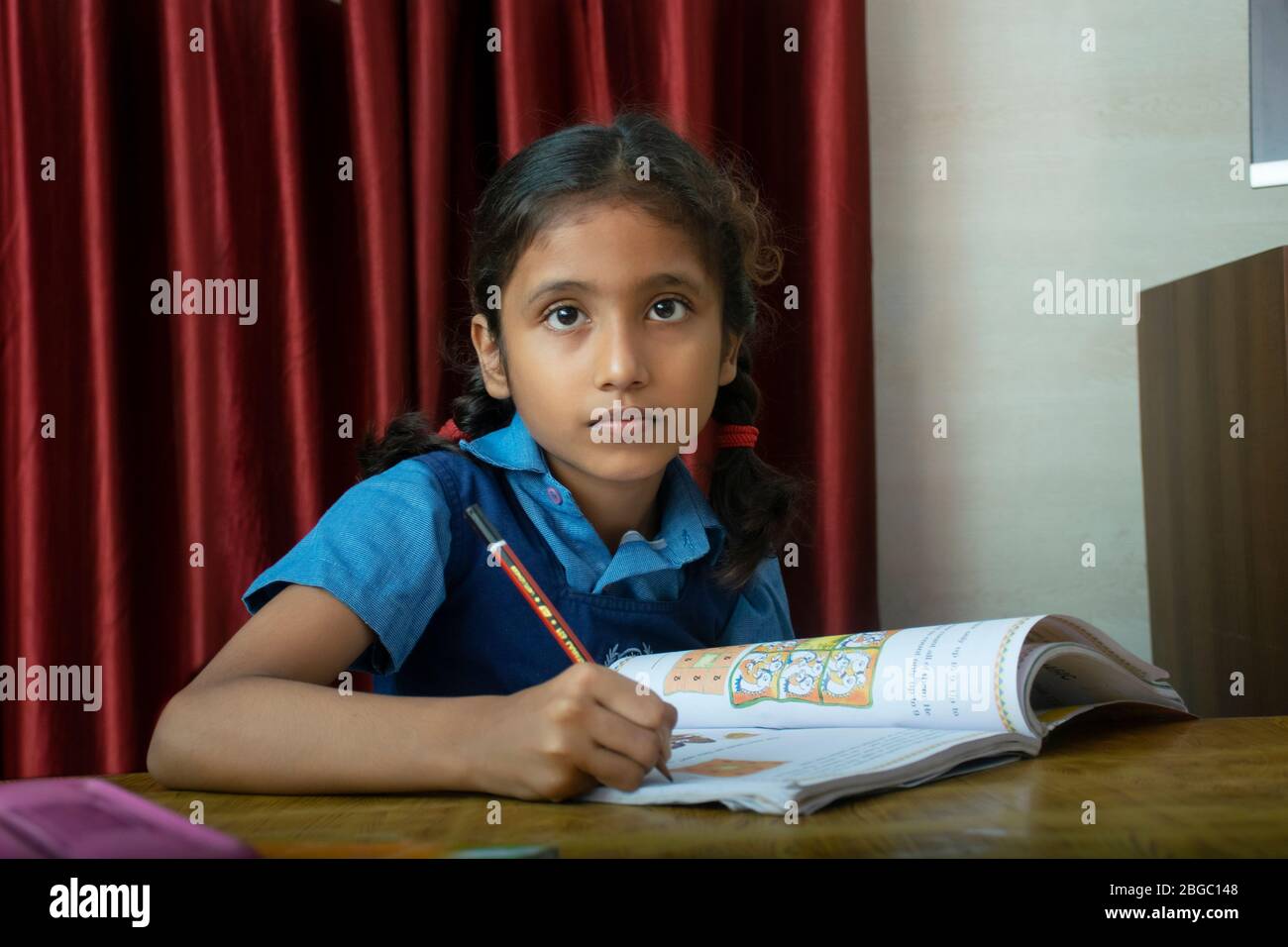 school girl writing with pencil Stock Photo - Alamy