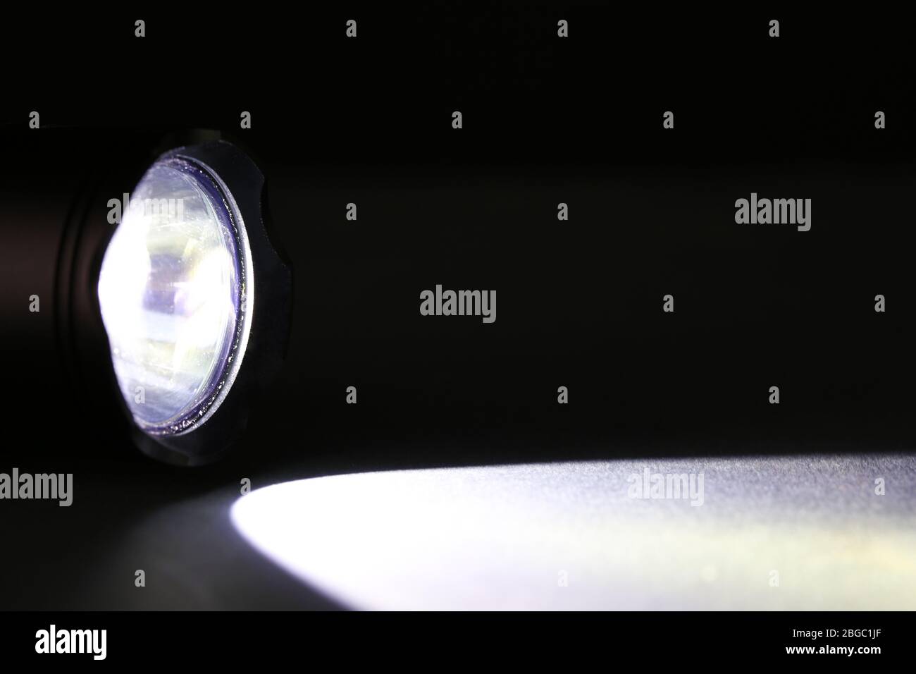Beam from flashlight closeup on dark background Stock Photo - Alamy