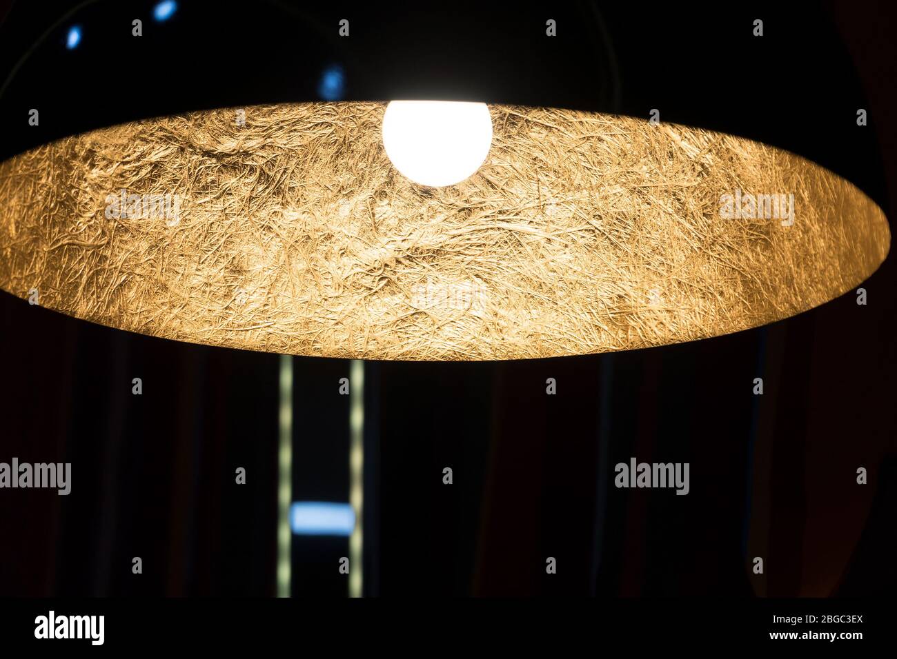 A burning lamp under a shade in a dark black room Stock Photo - Alamy