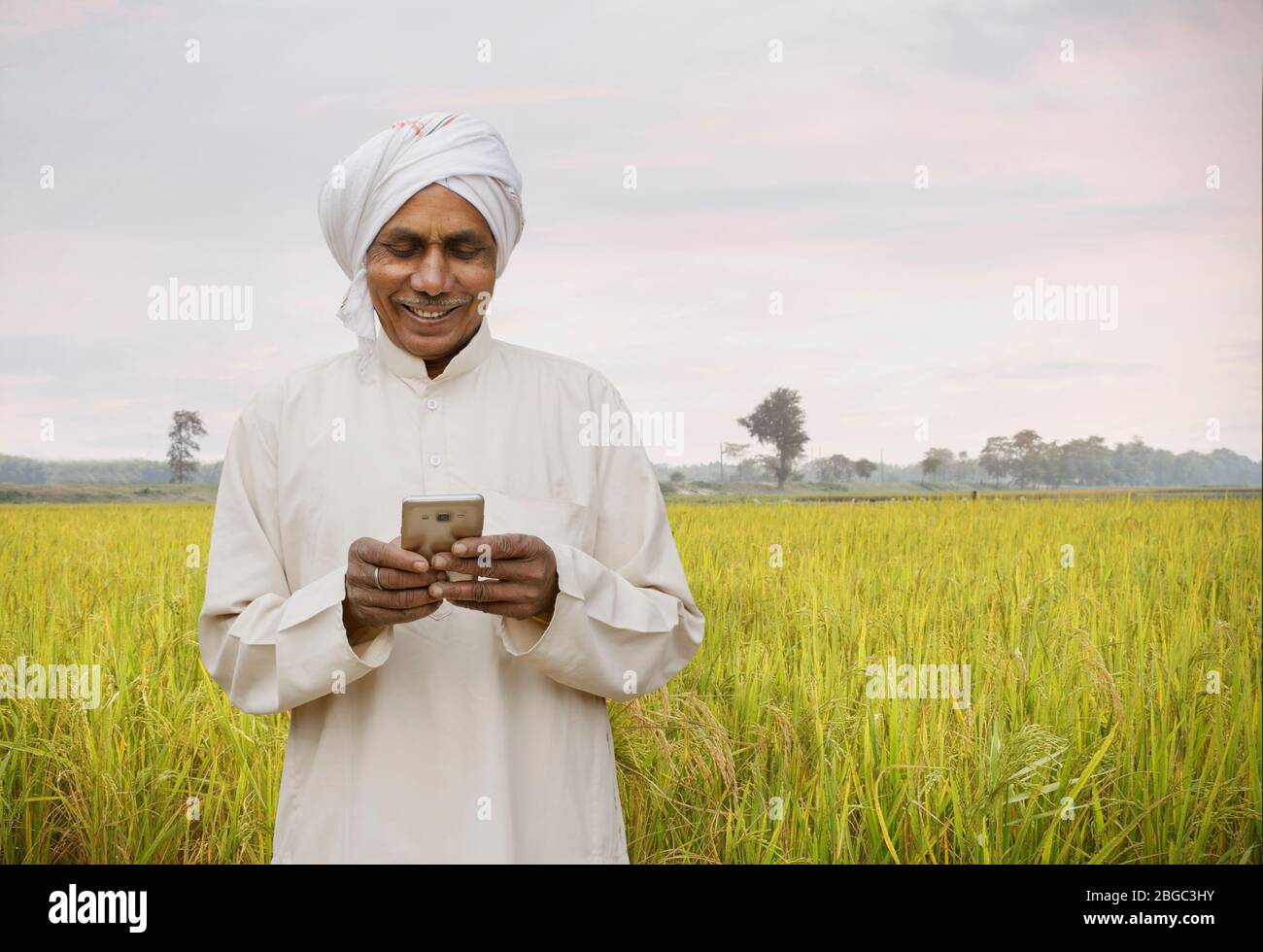 farmer with cellphone smiling Stock Photo - Alamy