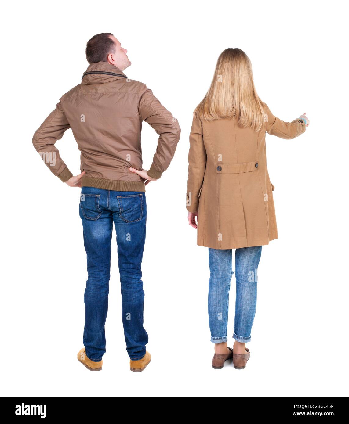 Back view of two pointing girl in winter jacket. Rear view people ...