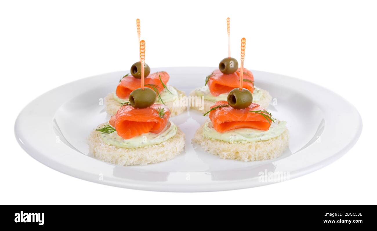 Delicious canapes on plate isolated on white Stock Photo - Alamy