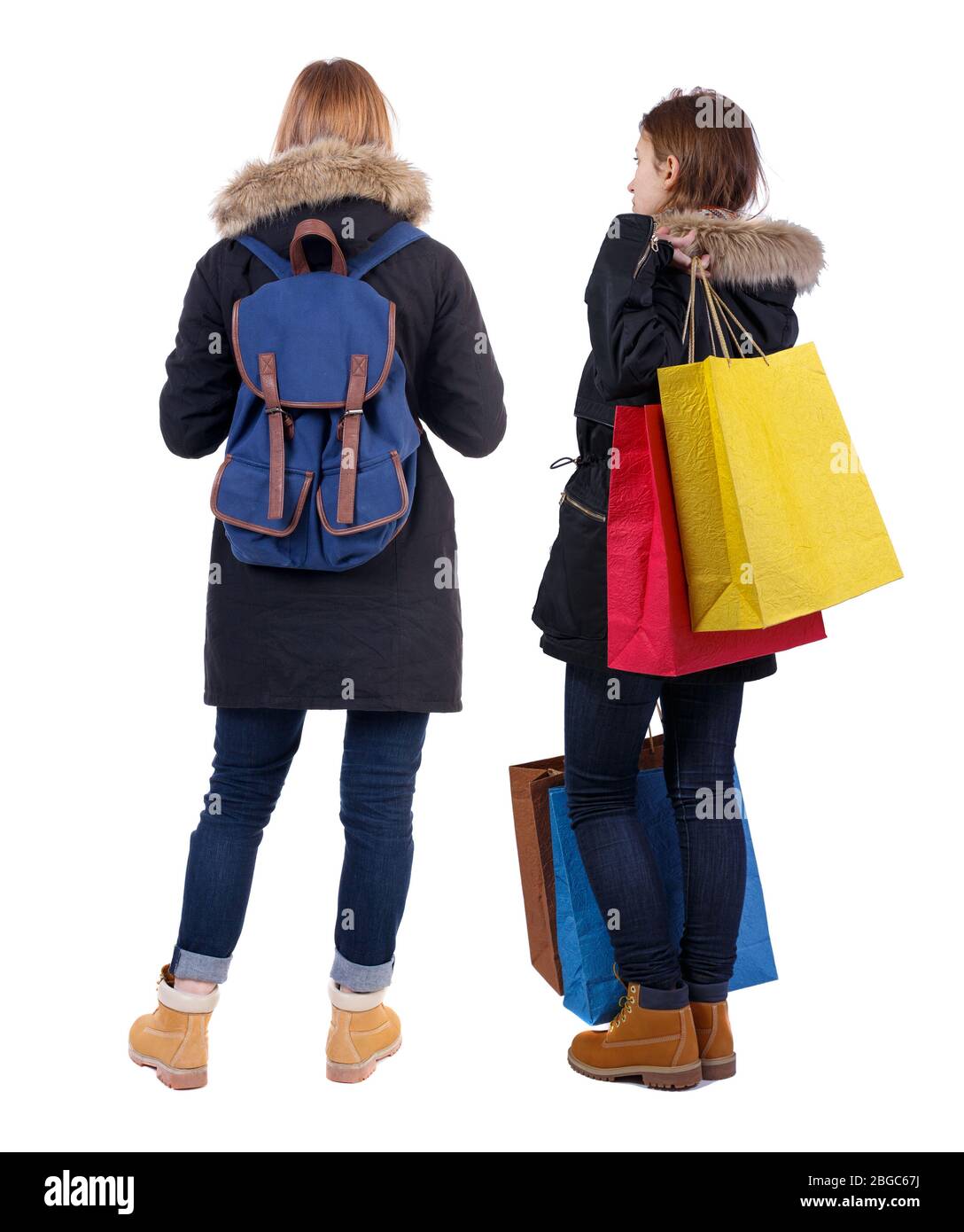 back view of two women with shopping bags in winter jacket. backside ...