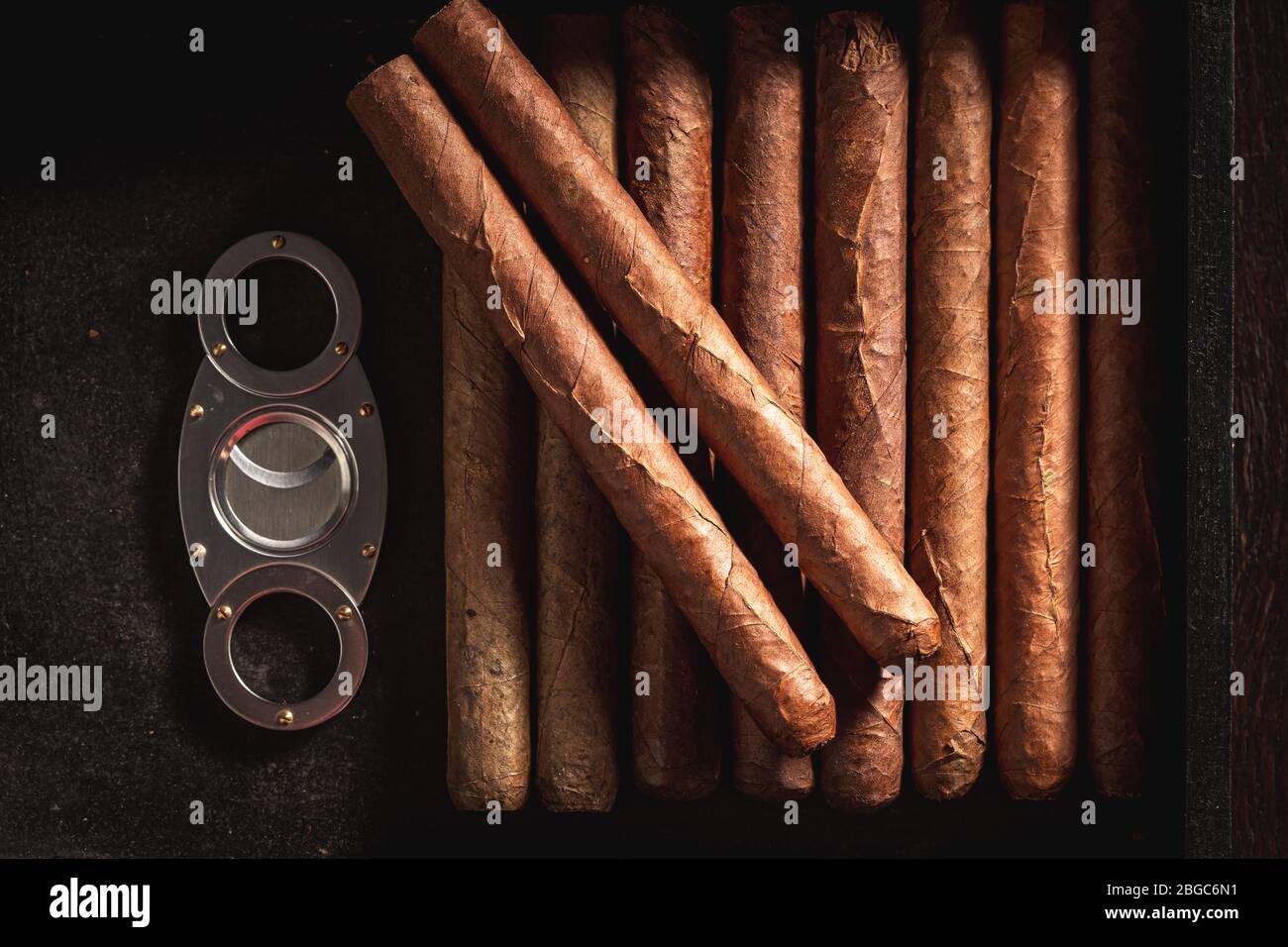 Top view of cigars with metal cutter in humidor Stock Photo - Alamy