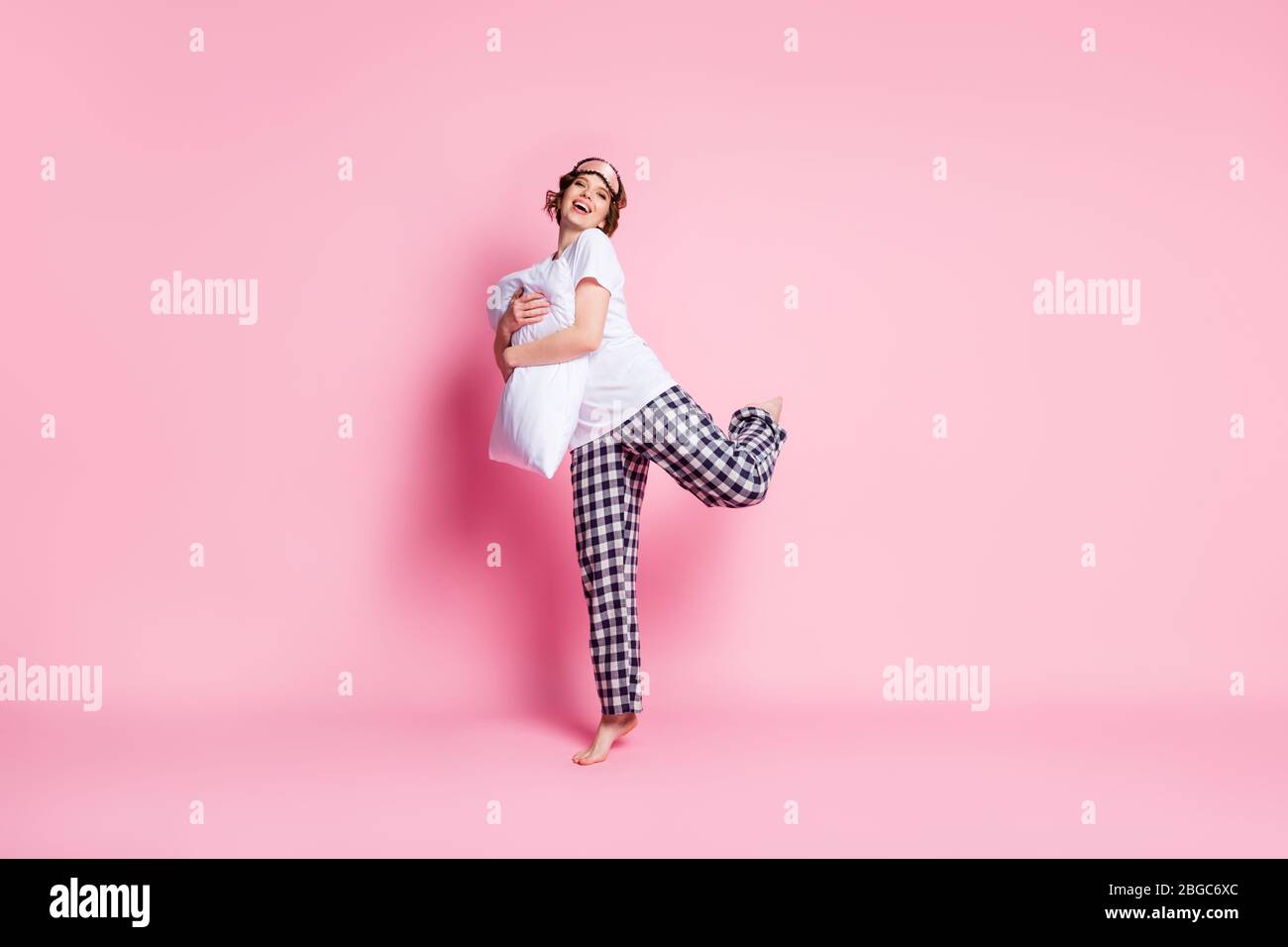 Full size photo of funny crazy lady hold hug pillow raise one leg good ...