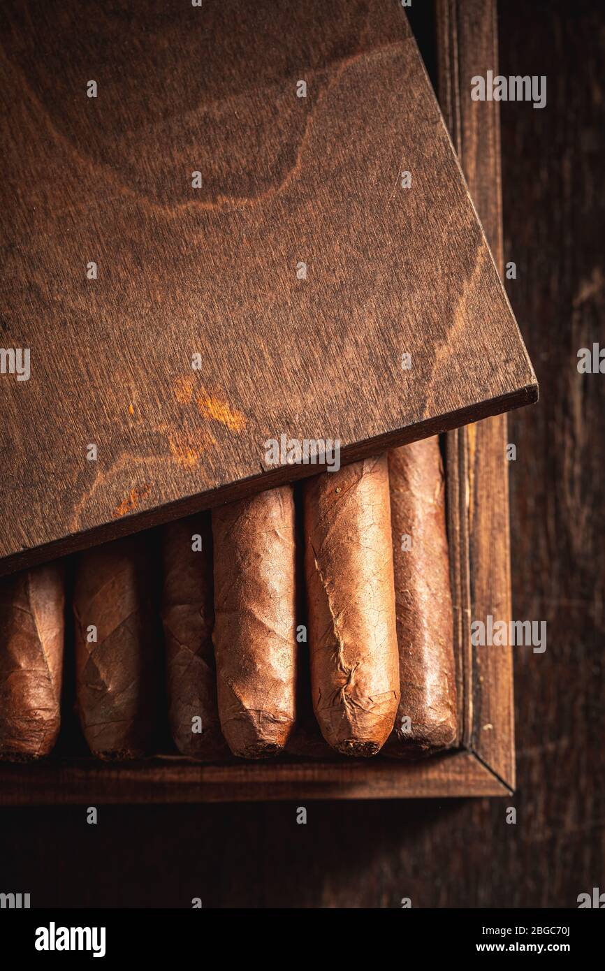 Top view of tasty cigars in rustic wooden box Stock Photo - Alamy