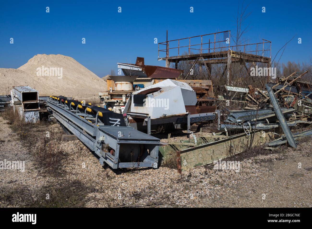 Group of various old rusted machines, used for extraction of a gravel ...