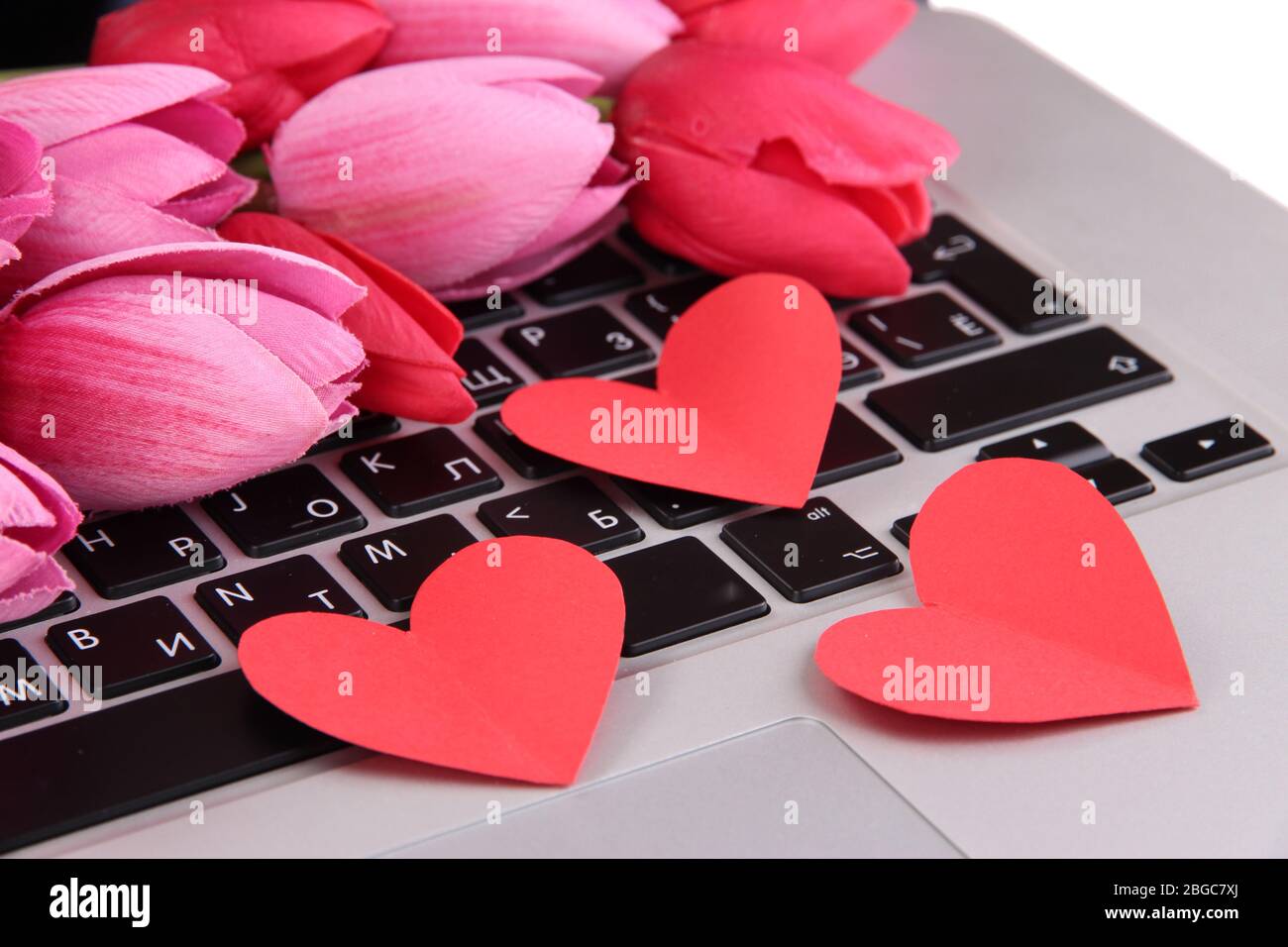 Red hearts and flowers on computer keyboard close up Stock Photo - Alamy