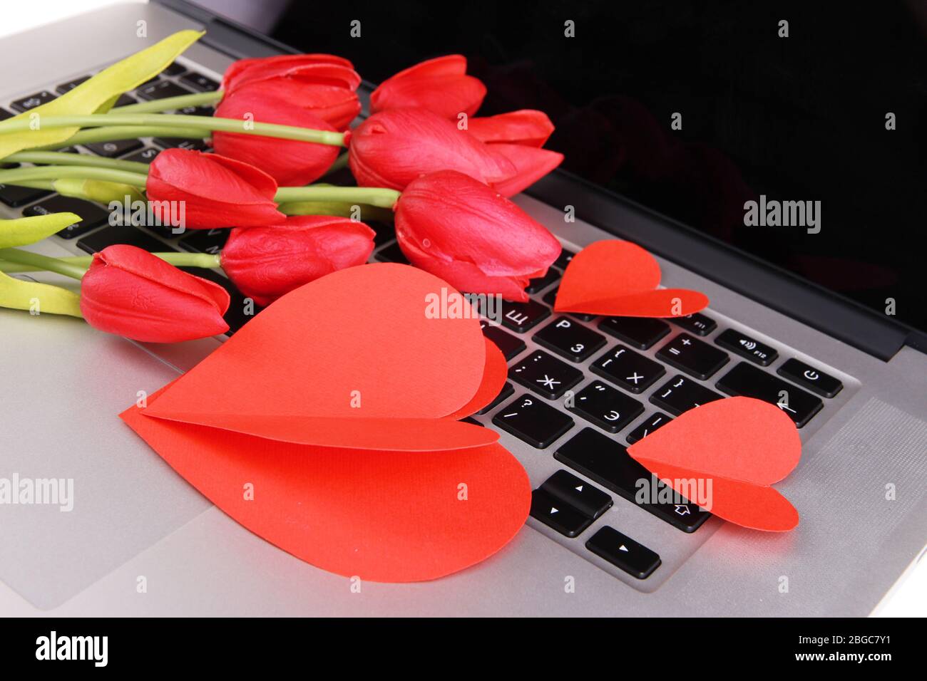 Red hearts and flowers on computer keyboard close up Stock Photo - Alamy