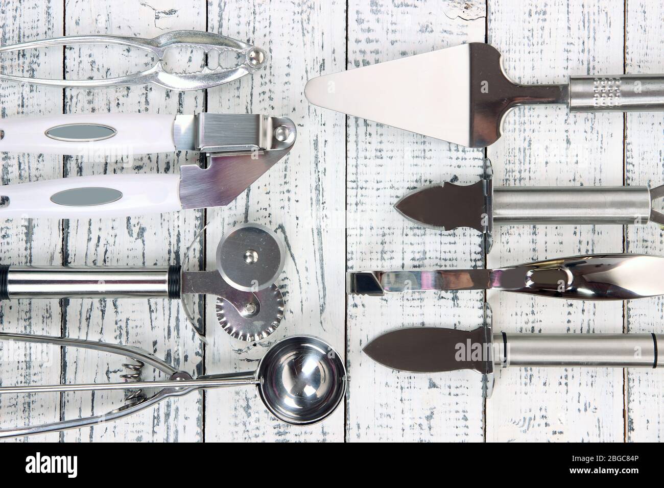 Metal kitchen utensils on table close-up Stock Photo - Alamy