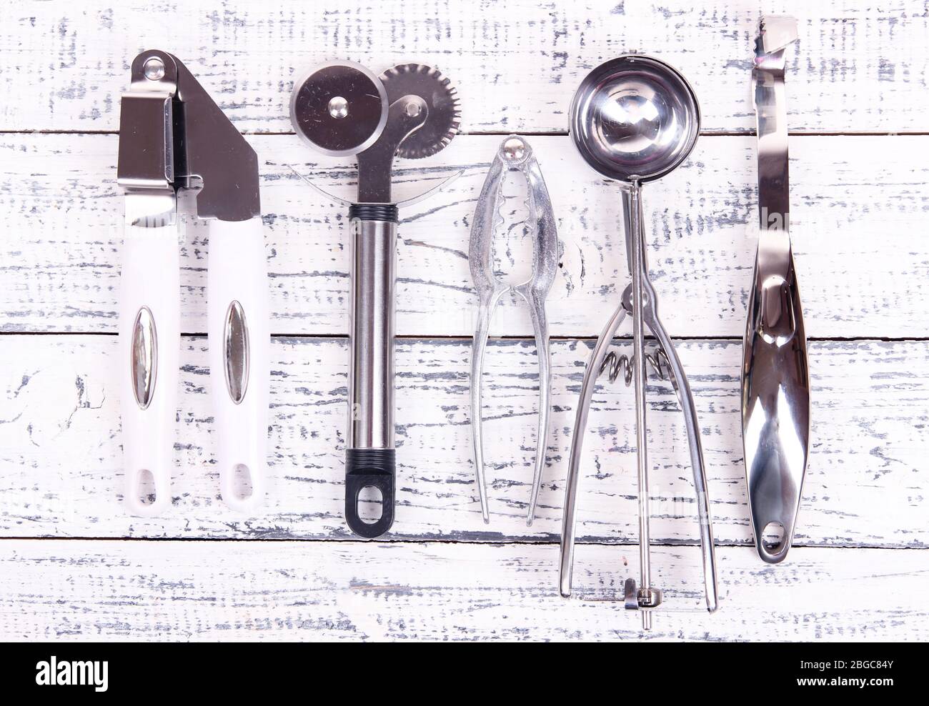 Metal kitchen utensils on table close-up Stock Photo - Alamy