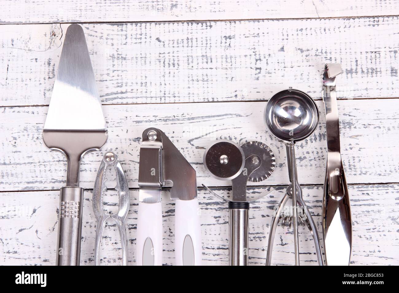 Metal kitchen utensils on table close-up Stock Photo - Alamy