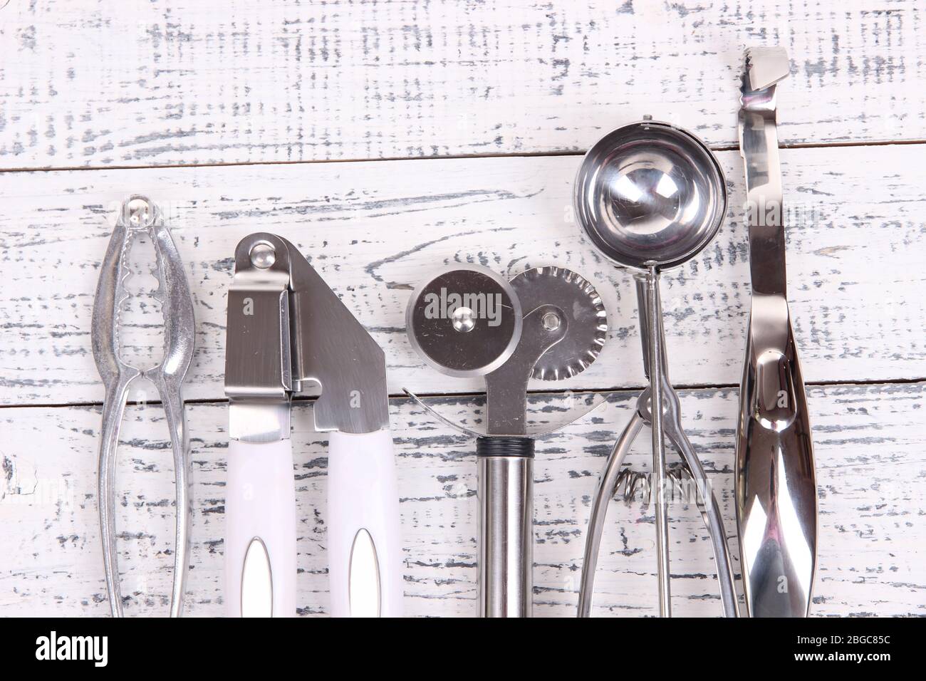 Metal kitchen utensils on table close-up Stock Photo - Alamy