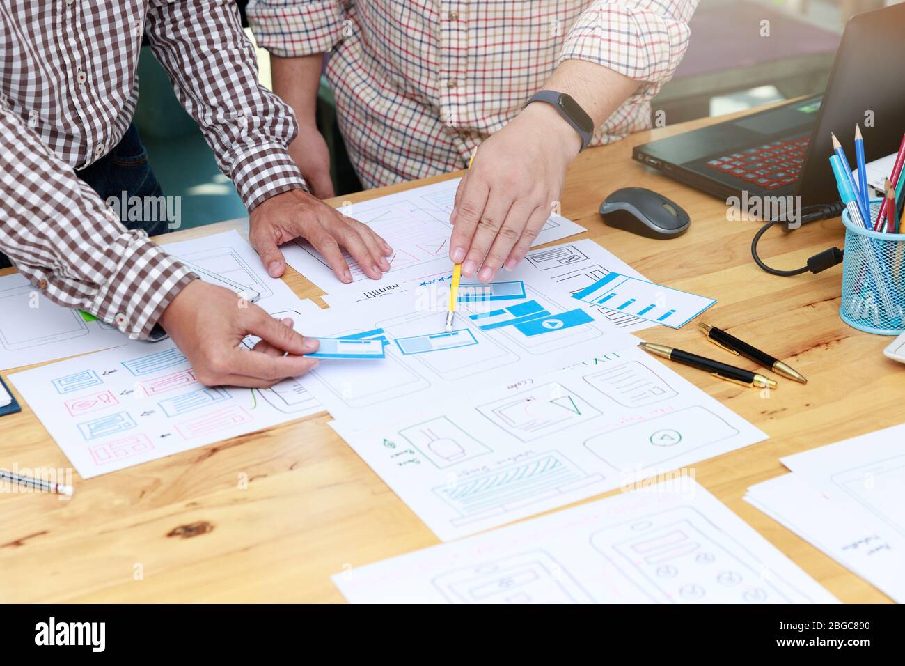 Graphic designers work together with UX UI designer planning ...
