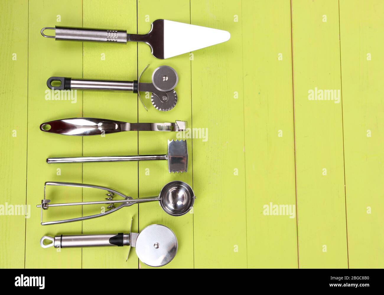 Metal kitchen utensils on table close-up Stock Photo - Alamy