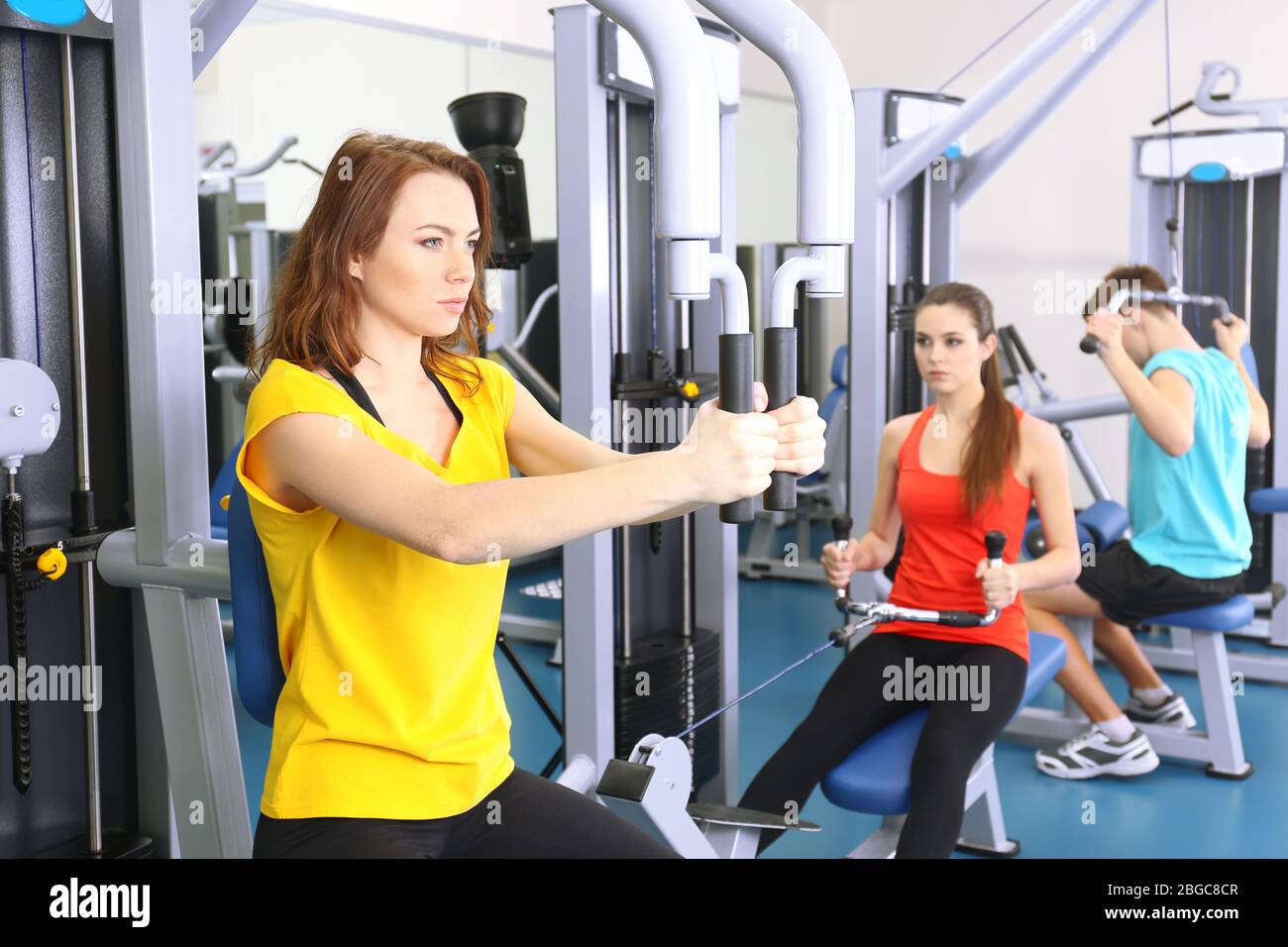 Group of people training with weights in gym Stock Photo - Alamy