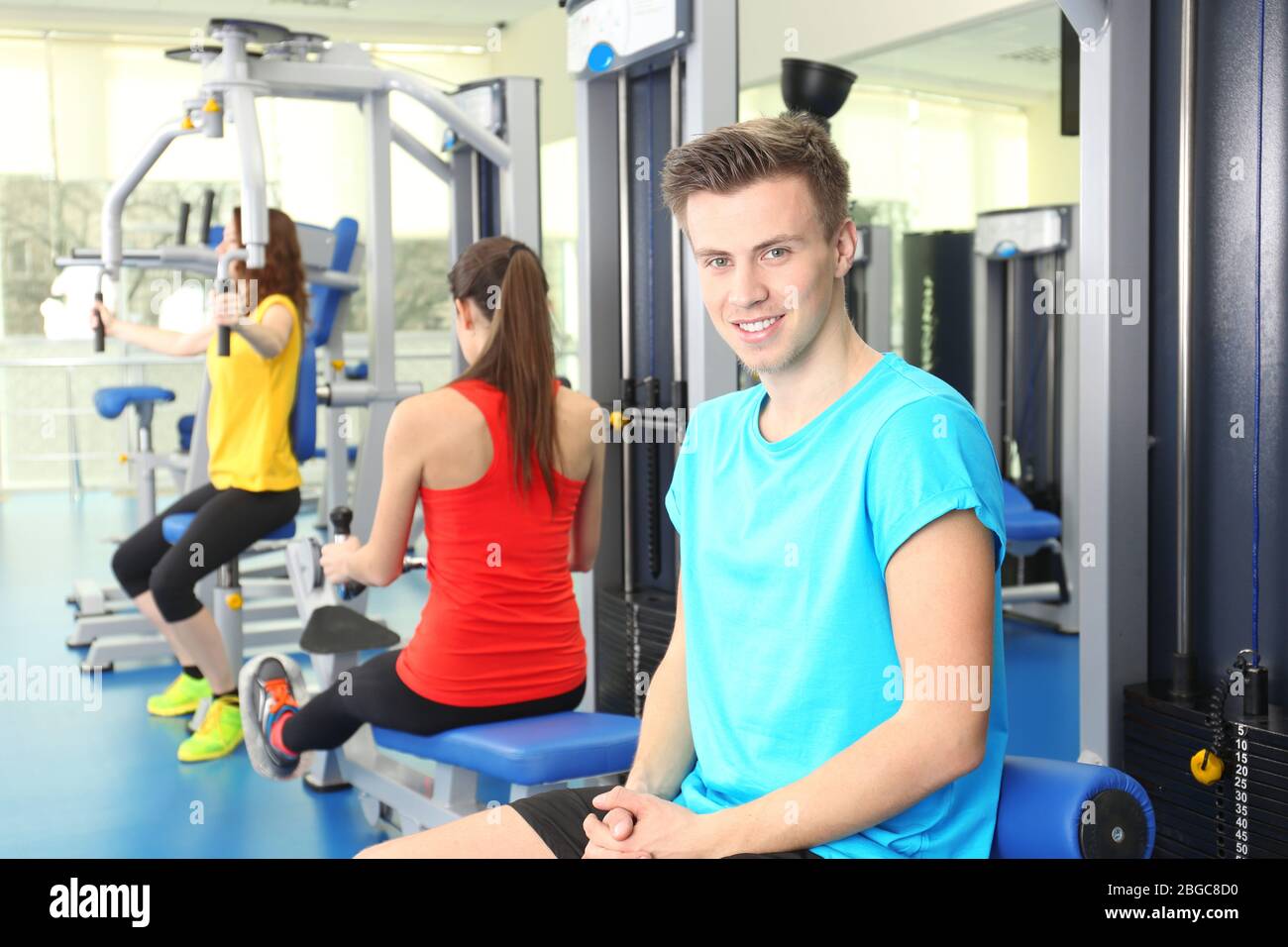 Group of people training with weights in gym Stock Photo - Alamy