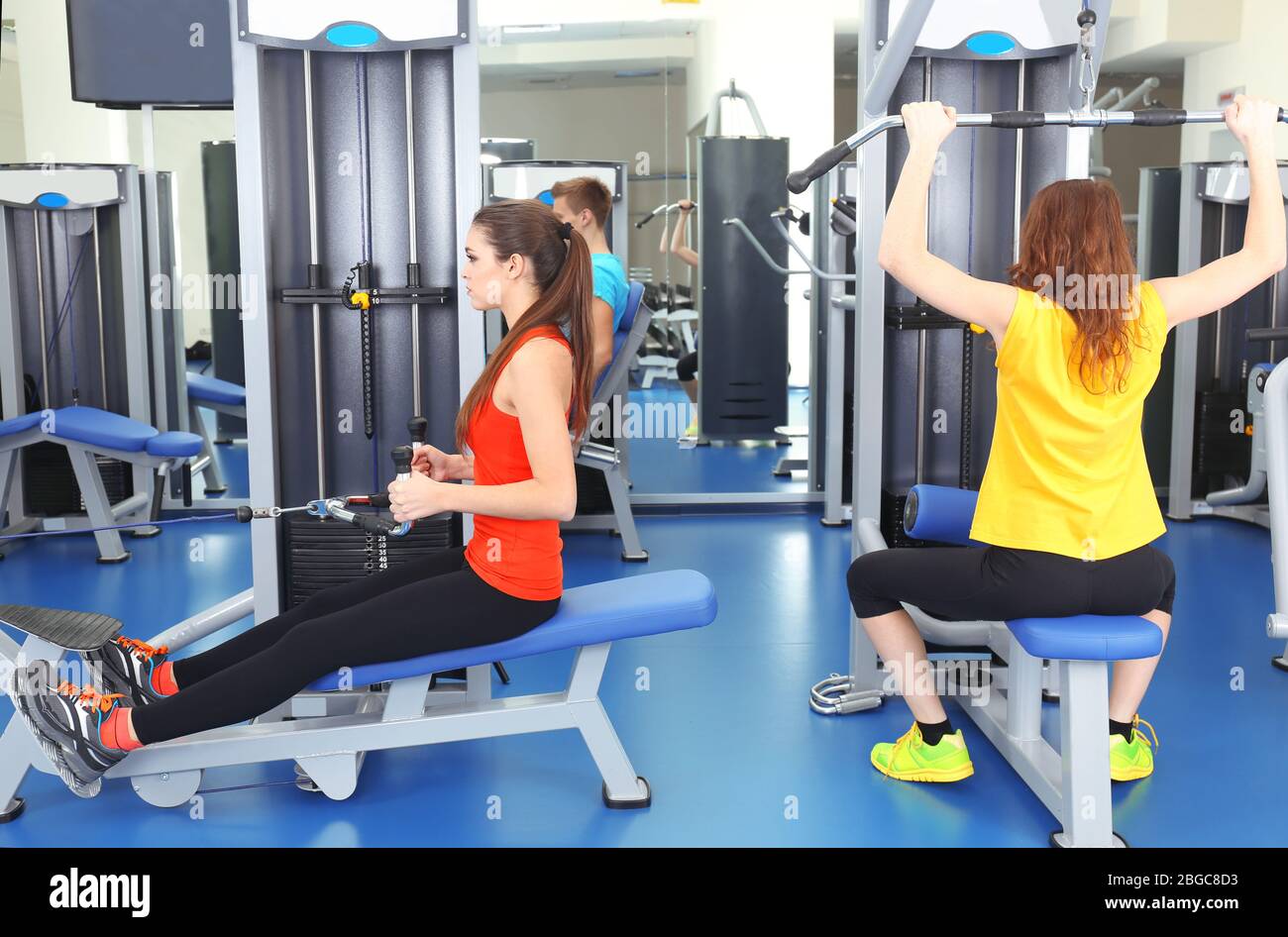 Group of people training with weights in gym Stock Photo - Alamy