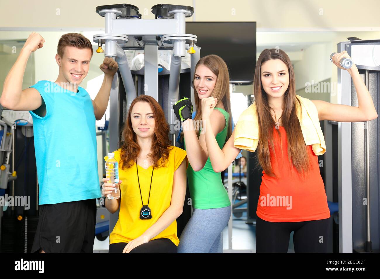 Group of people relaxing after training in gym Stock Photo - Alamy